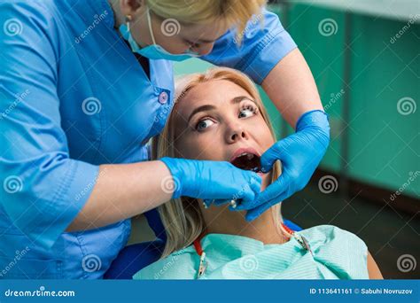 Female Dentist Treating Patient Girl Teeth Young Blonde Girl Sitting