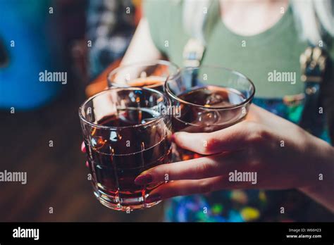 Male Hands Cheer With Glasses Of Shot Or Liqueur Friends Drink Shot Or