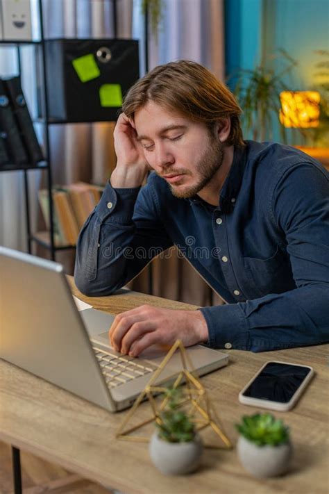 Bored Sleepy Businessman Worker Working On Laptop Computer Leaning On Hand Sleeps At Office