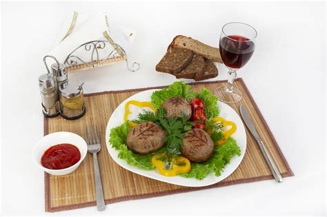 Cutlets With Greens Tomatoes And Cucumbers Serve With Black Or White