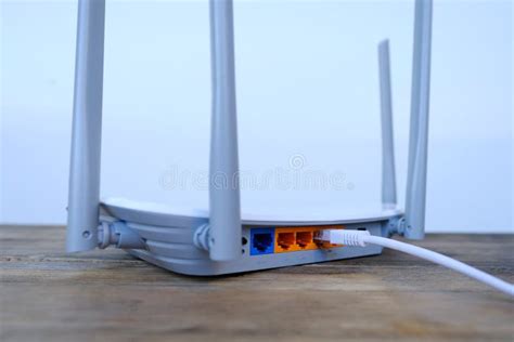 White Cable Is Plugged Into The Port Of Wi Fi Router Modern Wireless Router With Four Non