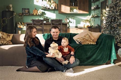Premium Photo Mom Plays With A Little Daughter Sitting On Her Father