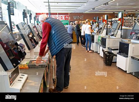 People Customers Shoppers Elderly Older Man Rear Back View Using Self