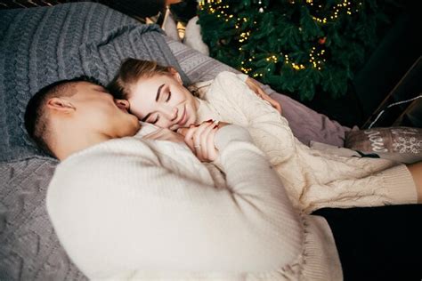 Premium Photo Couple In Love Near The Christmas Tree On The Bed