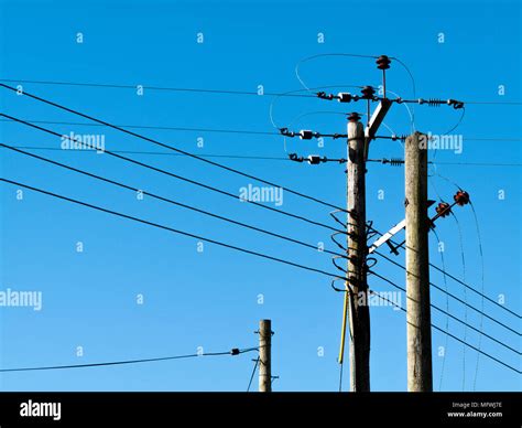Overhead Electrical Power Transmission And Distribution Cables Against A Clear Blue Sky Stock