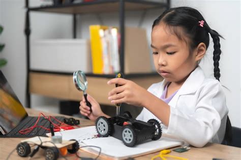 Premium Photo Asian Littlle Girl Constructing And Coding Robot At