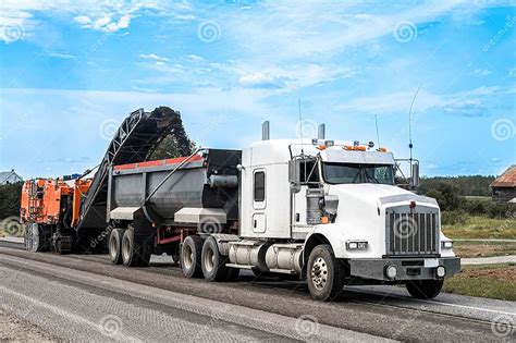 planer removing a layer of asphalt and tranferring it to a dump truck