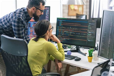 Software Programmers Analyzing Html Code And Database Brainstorming Script Ideas To Develop New