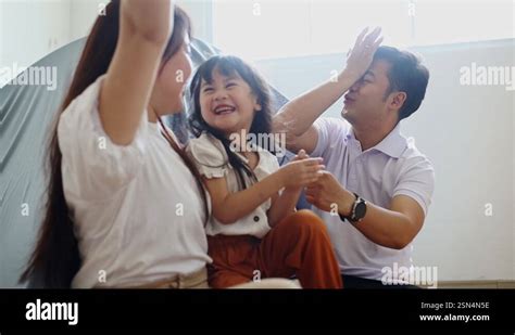Happy Asian Father And Daughter Playing The Game Rock Paper Scissors