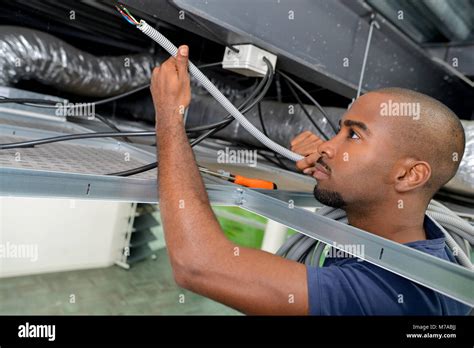 Man Holding On Electric Wires Stock Photo Alamy