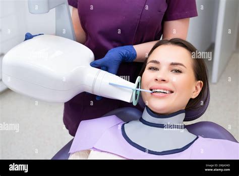 Process Of Preparation Of Patient Before Dental X Ray Procedure Woman Instructs Patient On How
