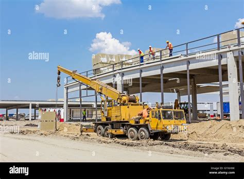 Mobile Crane Is Loading Cargo View On Construction Site With Machinery People At Work Stock