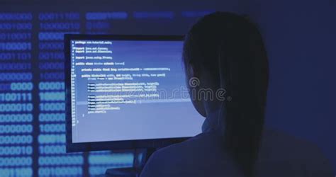 Portrait Of Young Woman Hacker Programmer Working At A Computer In The