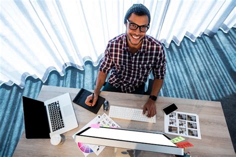 Premium Photo Attractive Hipster Man Smiling While Working At Desk