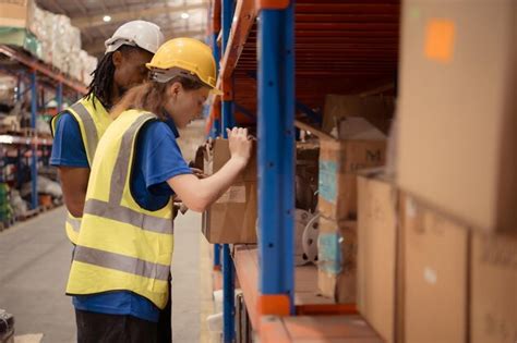 Premium Photo Male And Female Employees Work To Check The Goods In The Warehouse It Is A