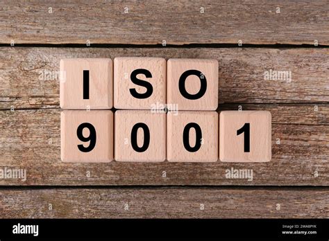 International Organization For Standardization Cubes With Abbreviation Iso 9001 On Wooden Table