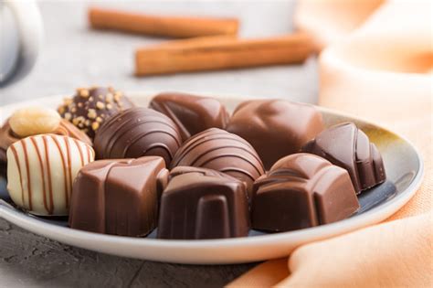 회색 콘크리트 배경과 오렌지 섬유에 다른 초콜릿 사탕과 커피 한 잔 측면 보기 클로즈업 선택적 초점 0명에 대한 스톡 사진 및 기타 이미지 Istock