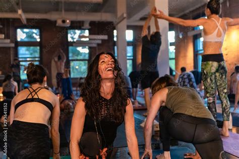 Diverse Group Of People In Yoga Class An Elated Woman Is Seen In Lying