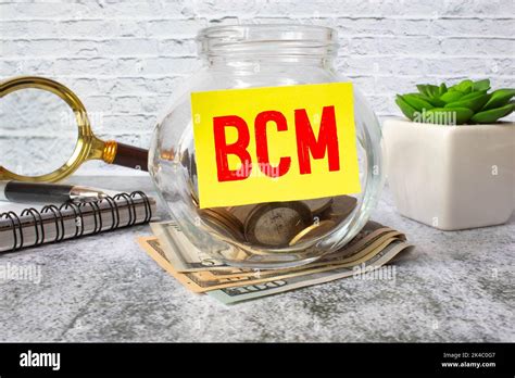 Text BCM BUSINESS CONTINUITY MANAGEMENT On The Dollars Background Business Concept Stock Photo