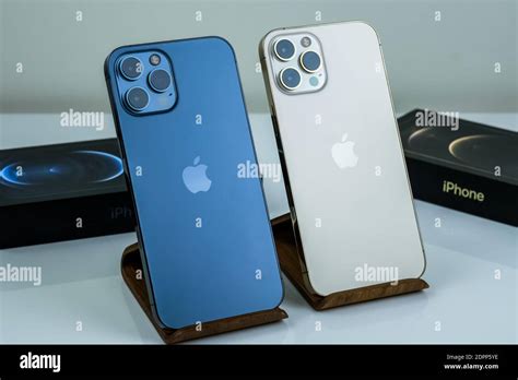 Iphone Pro Max Pacific Blue Next To Iphone Pro Max In Gold Stock Photo Alamy