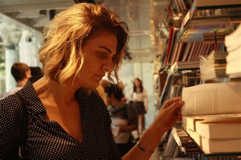 Premium Photo Mid Adult Woman Looking Books In Library