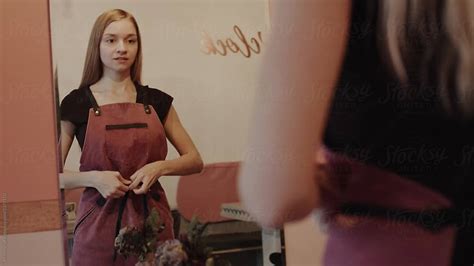 Woman Checking Uniform Before Starting Workday By Stocksy Contributor Milles Team Stocksy