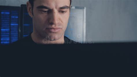 Portrait Of Developer Programmer Working On Computer In A Data Center Filled With Monitor