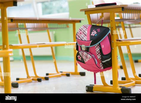 Pink Girly School Bag And Pencil Case On A Desk In An Empty Classroom First Day Of School