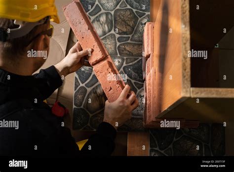 The Manual Worker Tries On A Tile To A Tile To Assess Whether It Will Fit Exactly Together An
