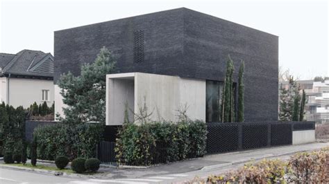Villa Blends Exposed Concrete And Black Brick Concrete Connect