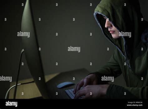 A Hacker In A Hood On A Dark Background Hacking Computer Networks Stock