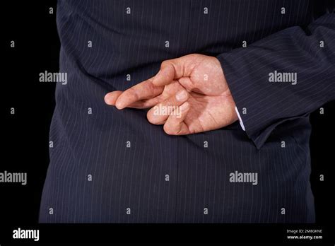 Telling Lies Cropped View Of A Man In A Suit Wth His Fingers Crossed Behind His Back Stock