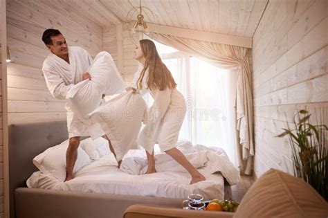 Happy Couple Having Fun Pillow Fight In Bedroom Stock Image Image Of