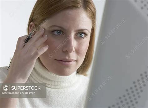 Woman Focused On Her Computer SuperStock