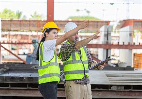 Senior Engineer And Female Foreman Team Checking Project At Precast Concrete Factory Site