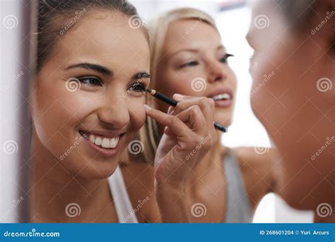 Getting Ready To Go Out Two Young Women Pampering Themselves At A