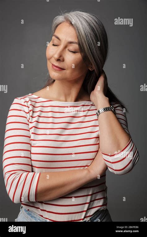 Image Of Adult Mature Woman Wearing Striped Shirt Standing With Eyes