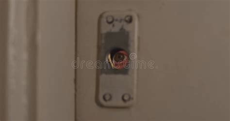 Female Eye Peeking Through A Keyhole Concept For Curiosity Stalker