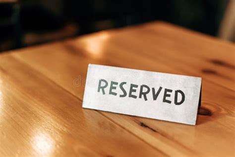 Reserved Plate On Wooden Table In Restaurant Minimal Details Around