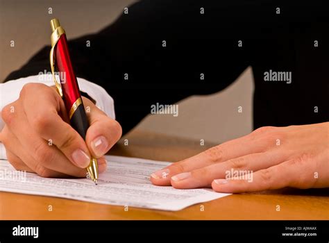 Female Signing A Form Stock Photo Alamy