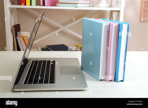 Stack Of Books With Laptop On Table In Room Stock Photo Alamy