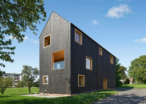 Blackened Timber House By Bernardo Bader Is On The Edge Of A Stream