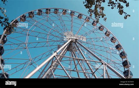 Ferris Wheel Over Blue Sky Ferris Wheel Against A Blue Sky On A Sunny