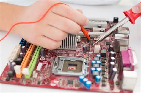 Premium Photo Technician Working On Broken Cpu With Soldering Iron