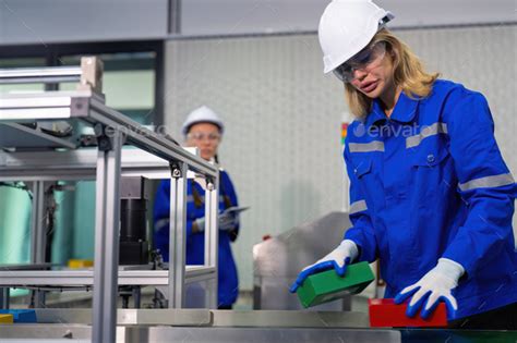 Automation Girls Engineer In Factory Testing Logistic Robot Arm Picking Boxes From Conveyor