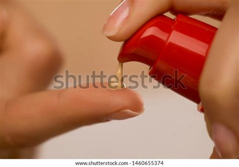 Squeezing Liquid Foundation From The Pump To The Finger Over 4 Royalty Free Licensable Stock