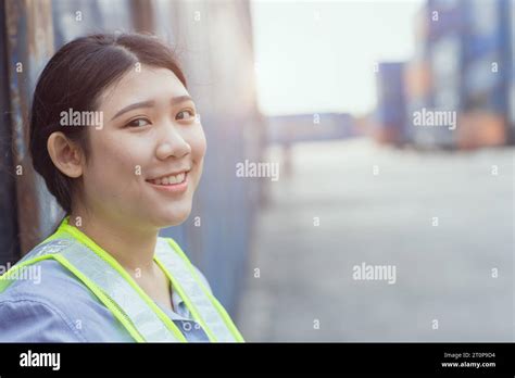 Asian Woman Happy Dock Worker Control Loading Containers Cargo At Shipyard Marine And Carrier