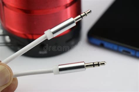Aux Cable Or Close Up Of Silver 3 5mm Audio Jack Cable With The Smartphone And External Speaker