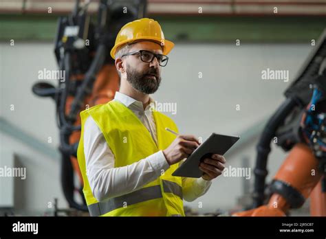 Automation Engineer Holding Digital Tablet In Industrial In Factory
