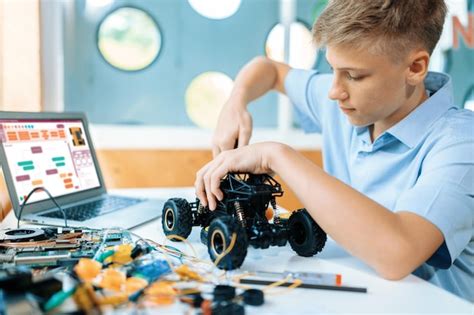 Premium Photo Student Fixing Robotics Vehicle Learn Technology In